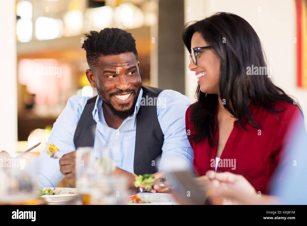 happy couple eating at restaurant Stock Photo - Alamy
