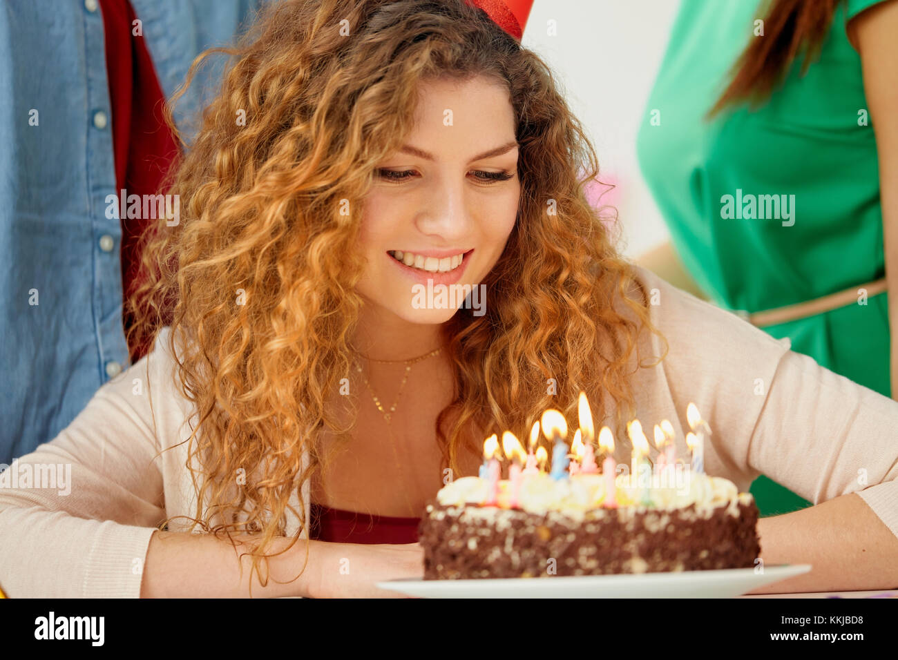 happy woman with candles on birthday cake at party Stock Photo - Alamy