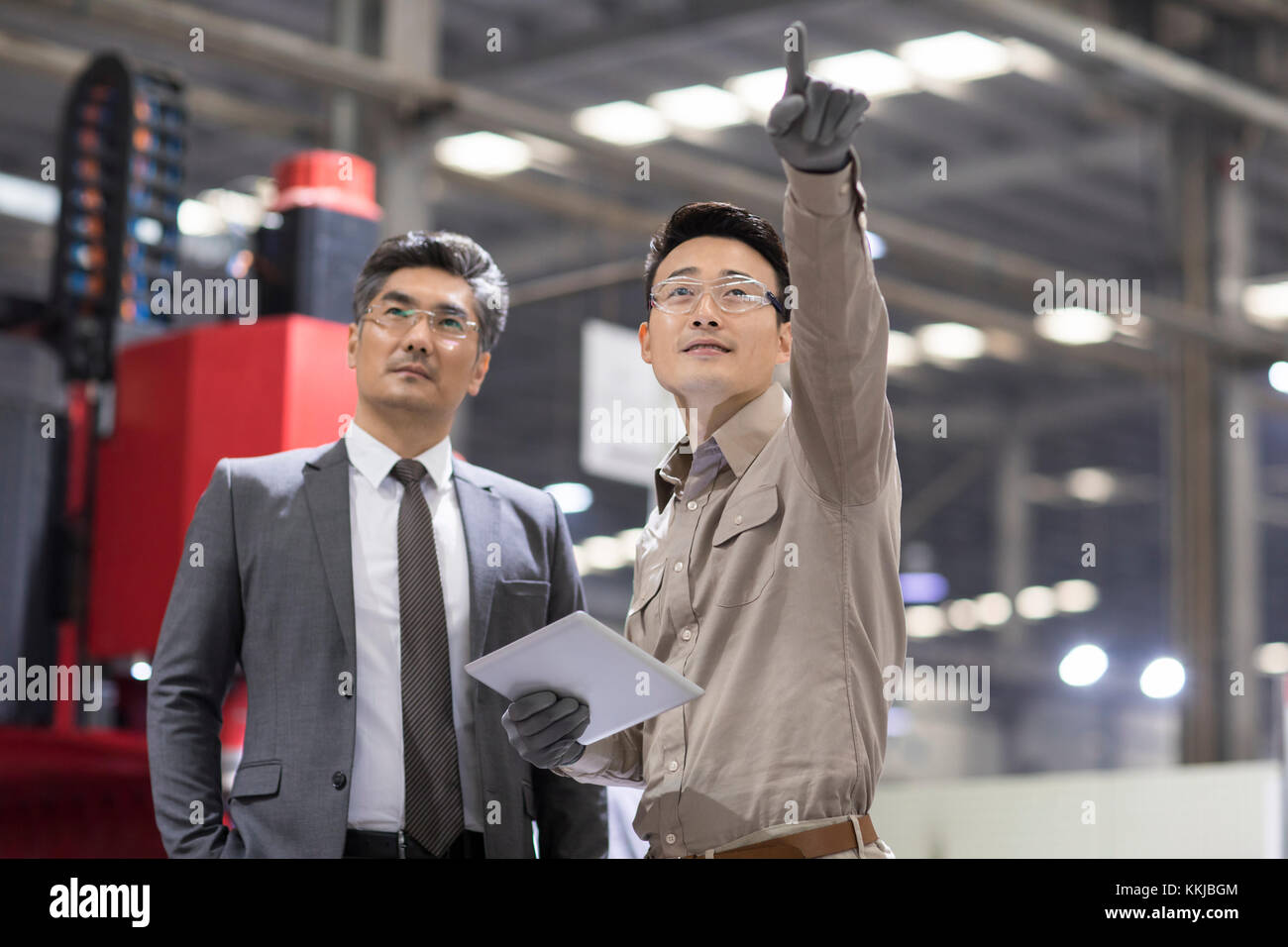 Chinese businessman and engineer talking in the factory Stock Photo - Alamy