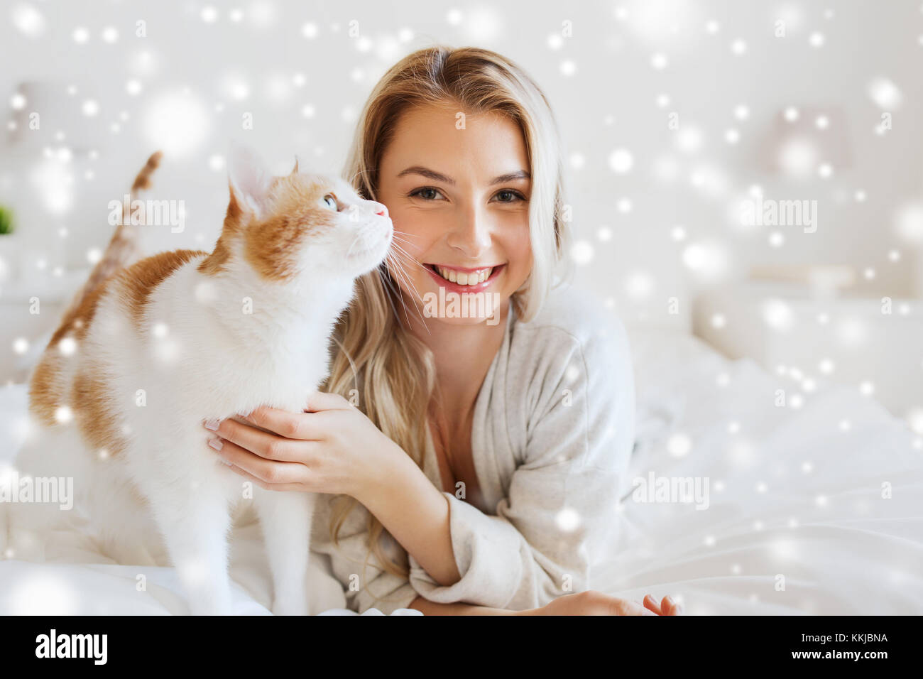 happy young woman with cat in bed at home Stock Photo - Alamy