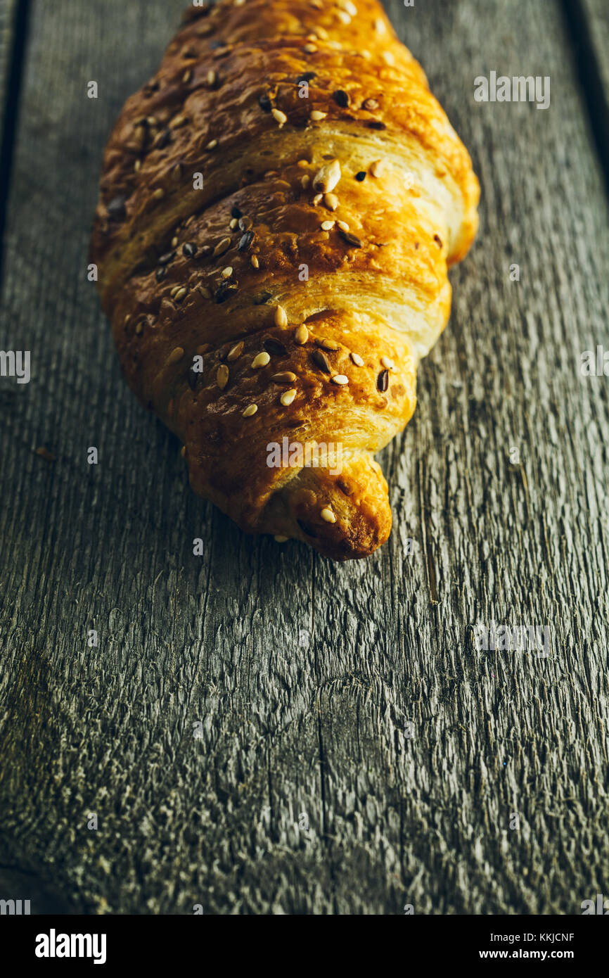 Crispy buttery croissants with seeds on old wooden table Stock Photo ...
