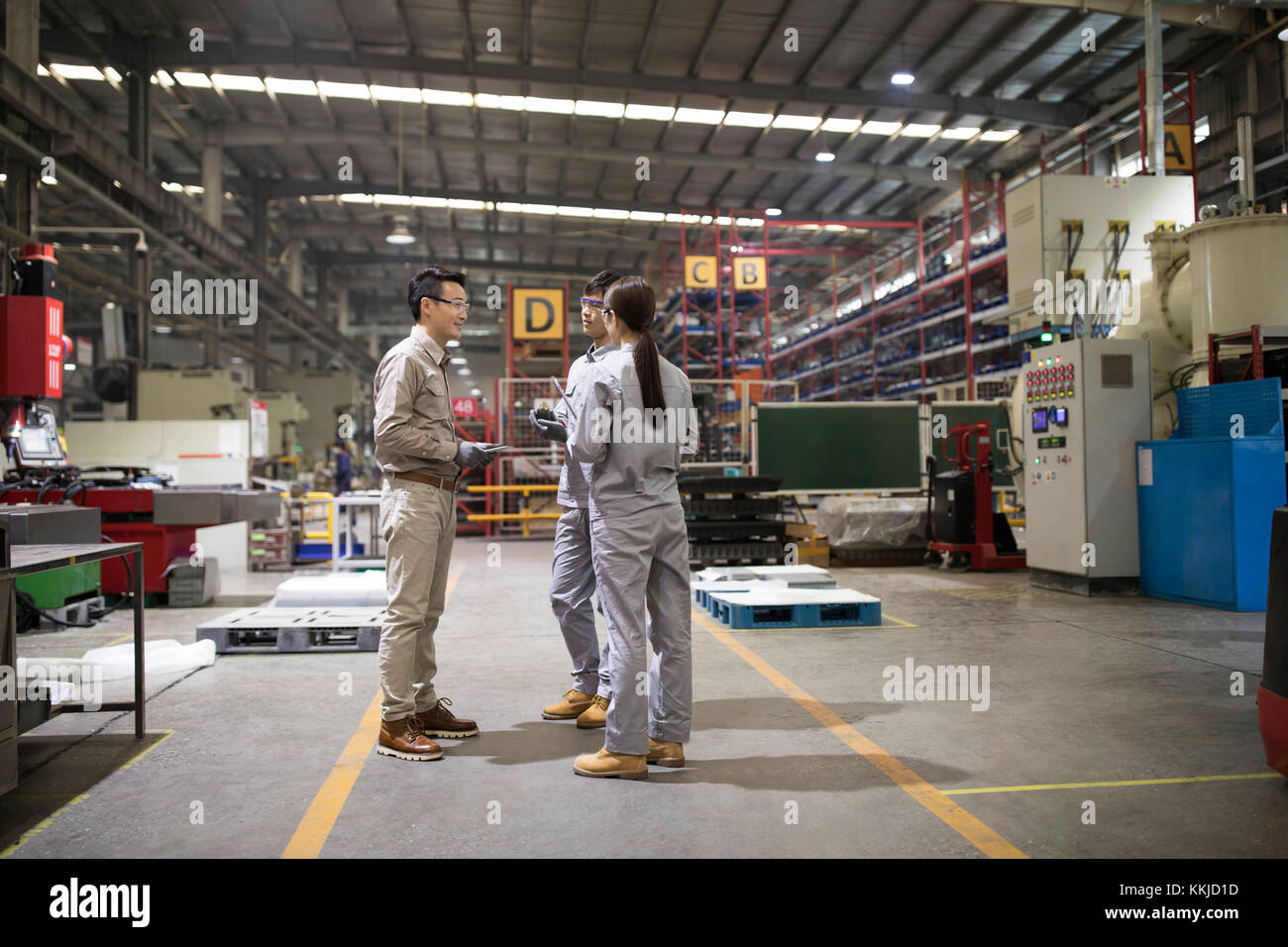 Confident Chinese engineers talking in the factory Stock Photo - Alamy