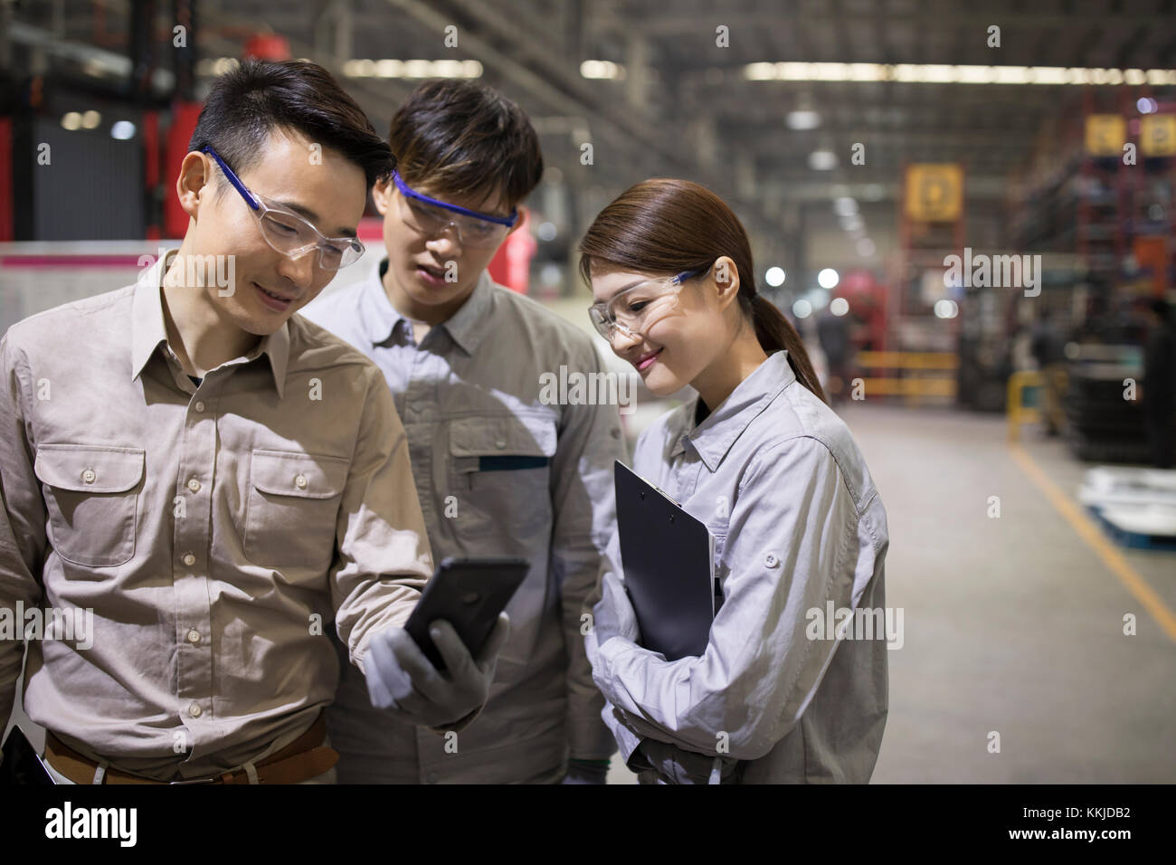 Confident Chinese engineers talking in the factory Stock Photo - Alamy