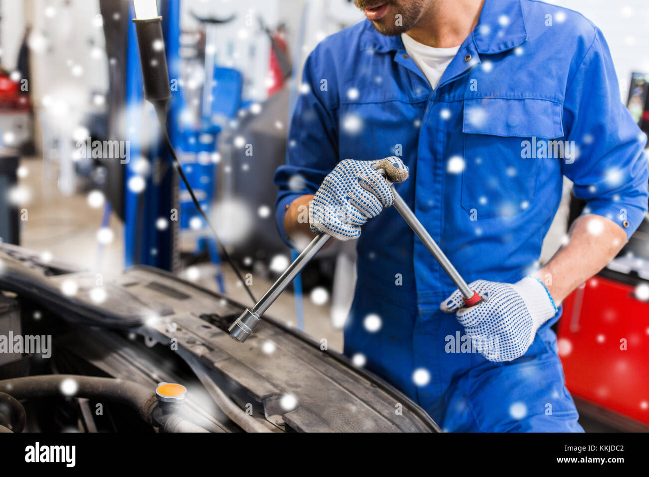 mechanic man with wrench repairing car at workshop Stock Photo - Alamy