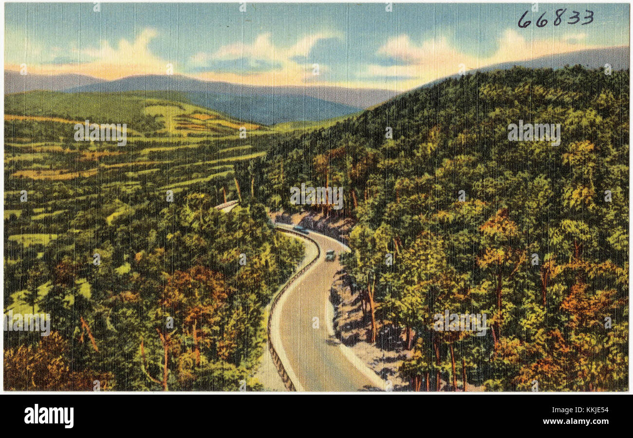 A scenic road winding through the mountains captures the beauty of the ...