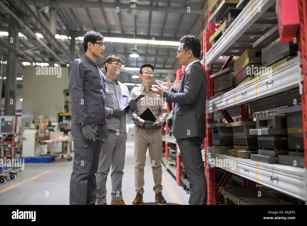 Chinese businessman and engineers talking in the factory Stock Photo ...