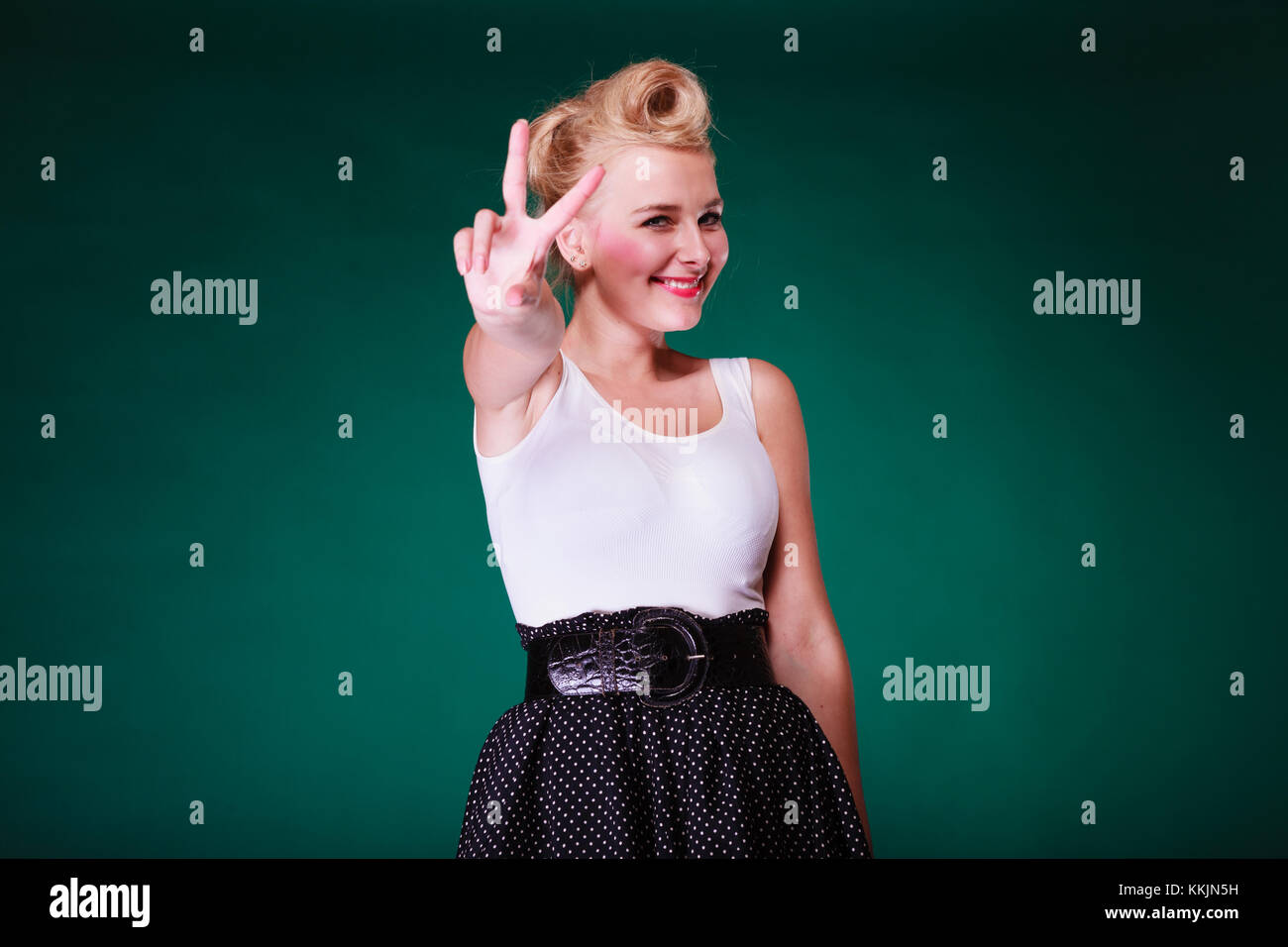 Signs, gestures concept. Lovely young pinup girl in retro black and ...