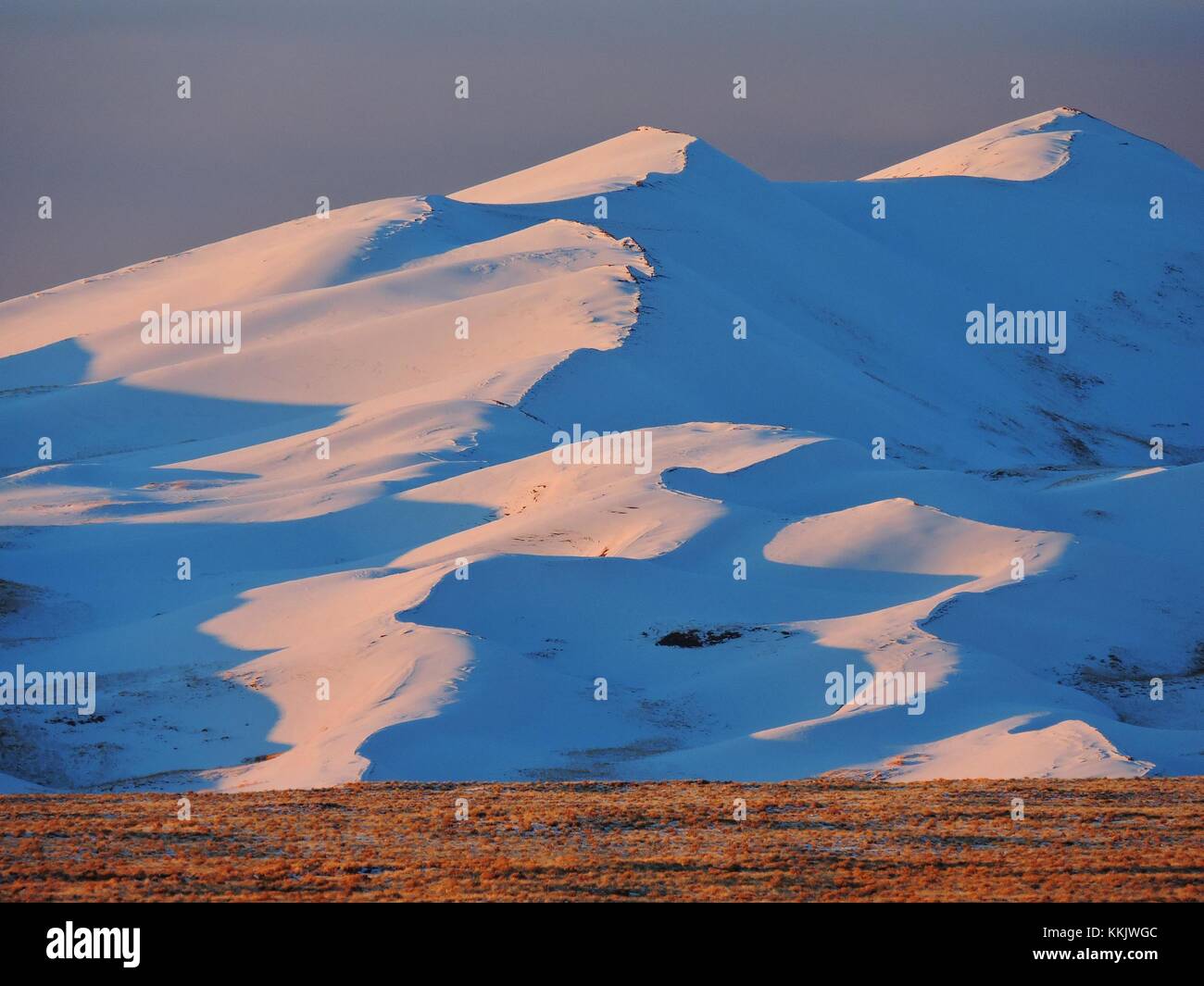 Snow covers the sand dunes and Cleveland Peak at the Great Sand Dunes ...