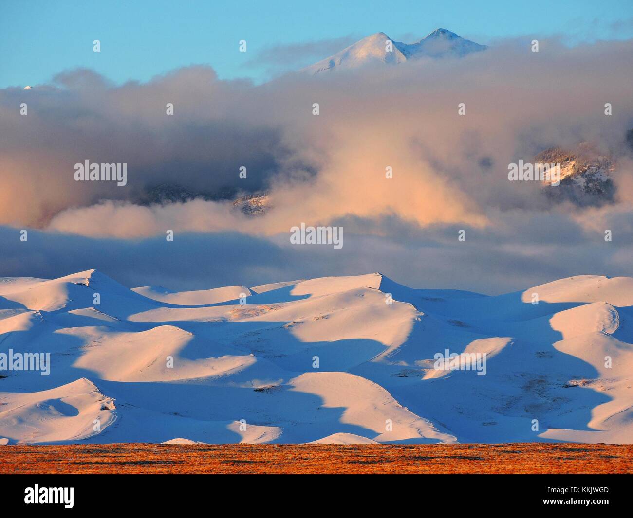 Spring snow covers the sand dunes and Cleveland Peak at the Great Sand ...