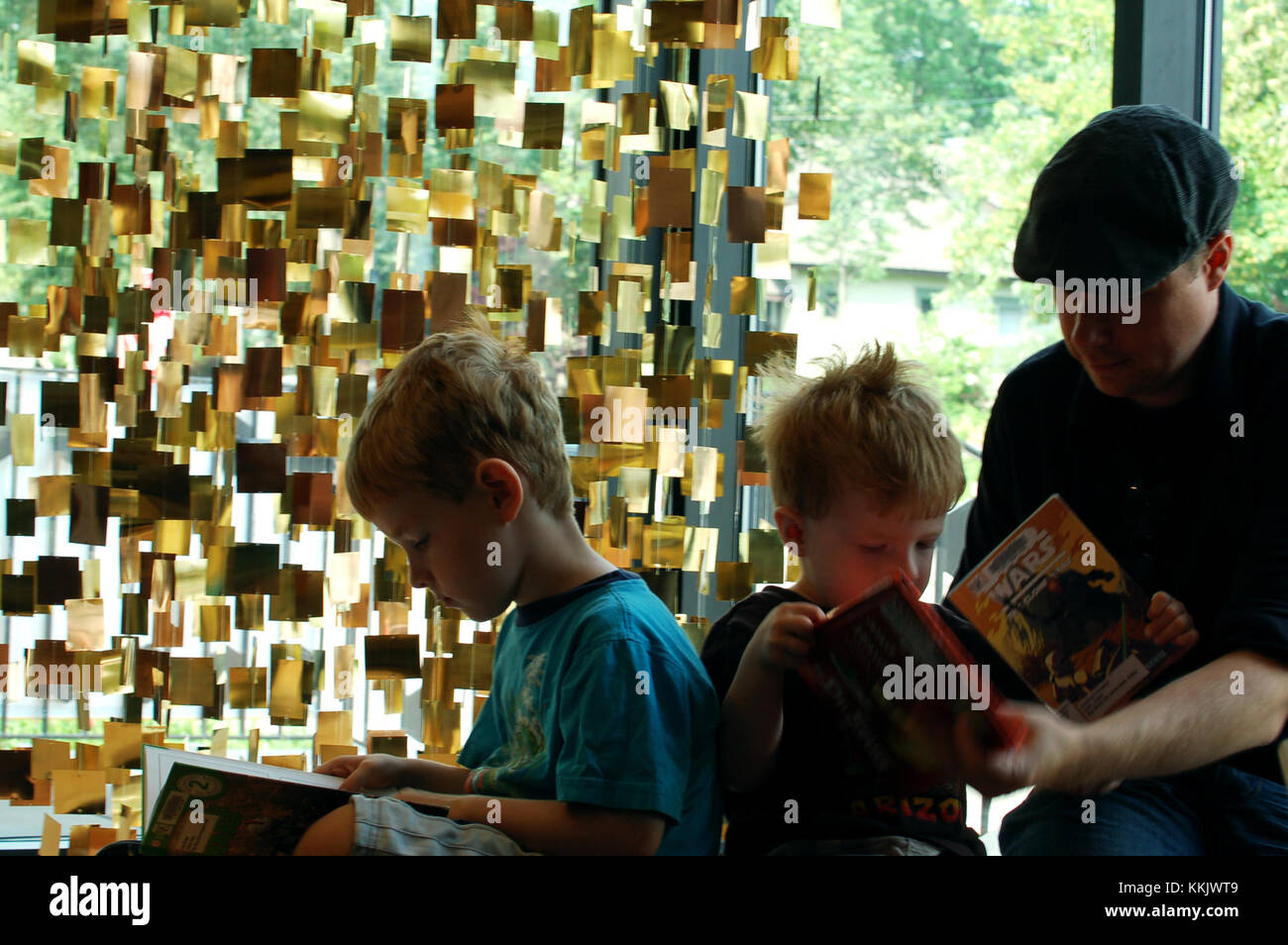Reading Beside Wind and Water Chime Stock Photo - Alamy