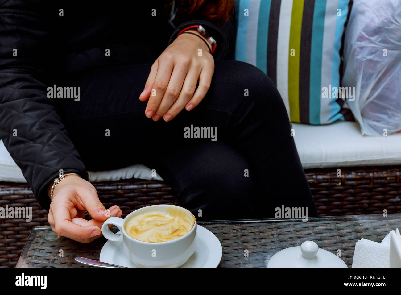 Woman's hands hugging a cup of coffee in a restaurant Stock Photo - Alamy