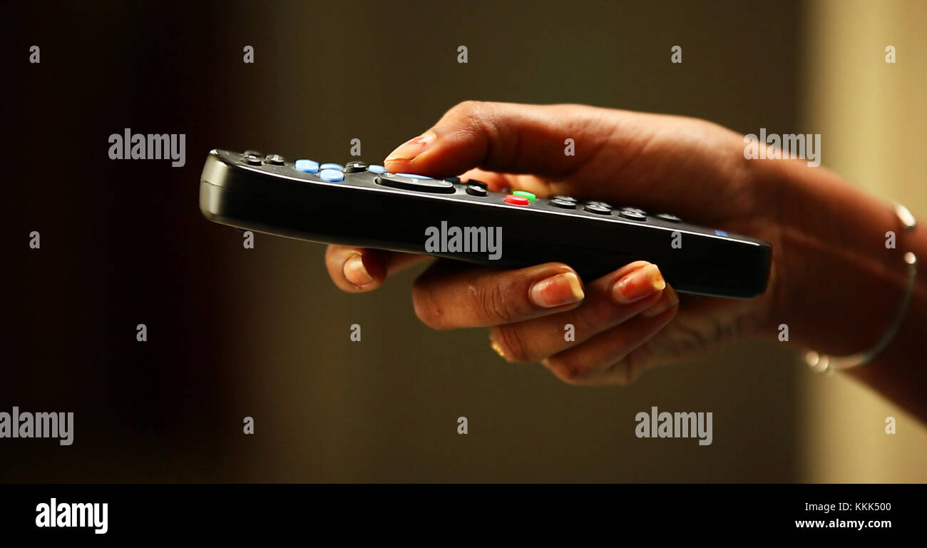 Close up Of TV Remote Changing Channels and Volume Increase, Teenage ...