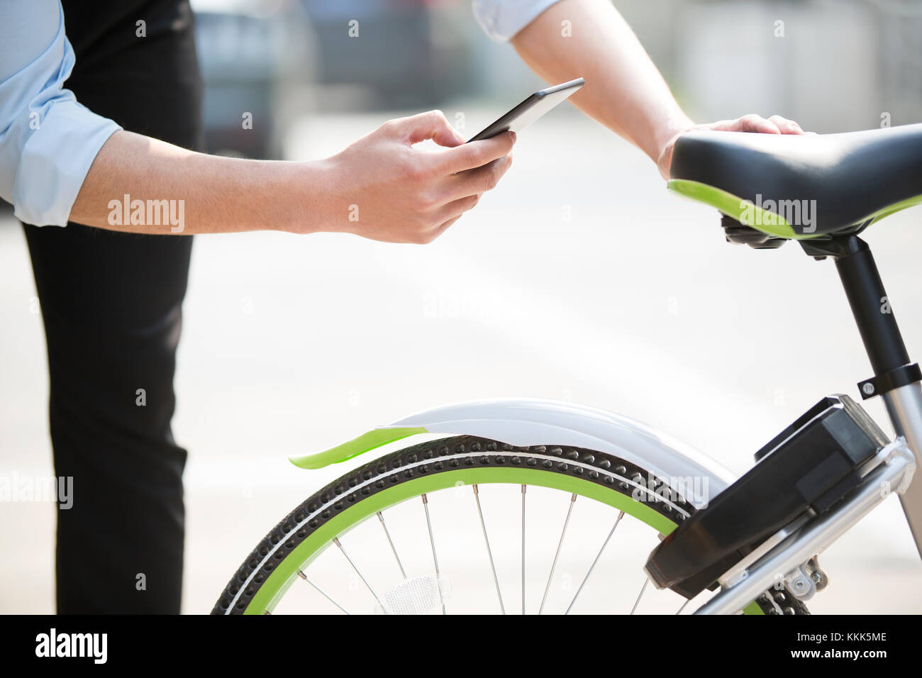 Young Chinese man scanning a QR code to unlock a share bike Stock Photo ...