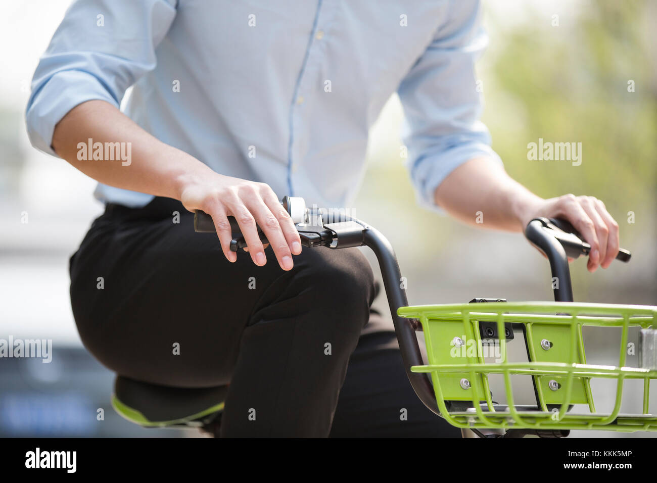 Young Chinese man riding a share bike Stock Photo - Alamy