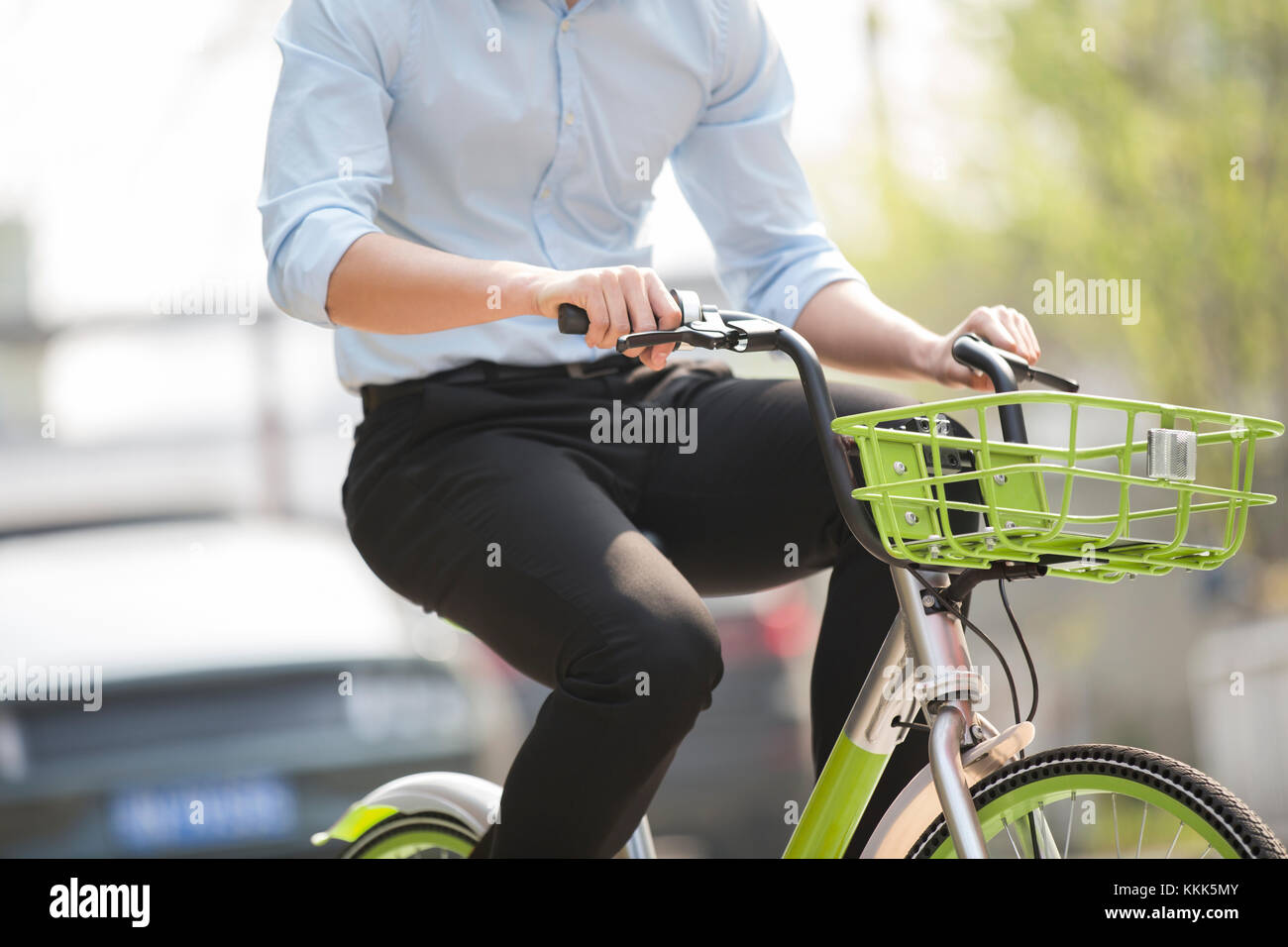 Young Chinese man riding a share bike Stock Photo - Alamy