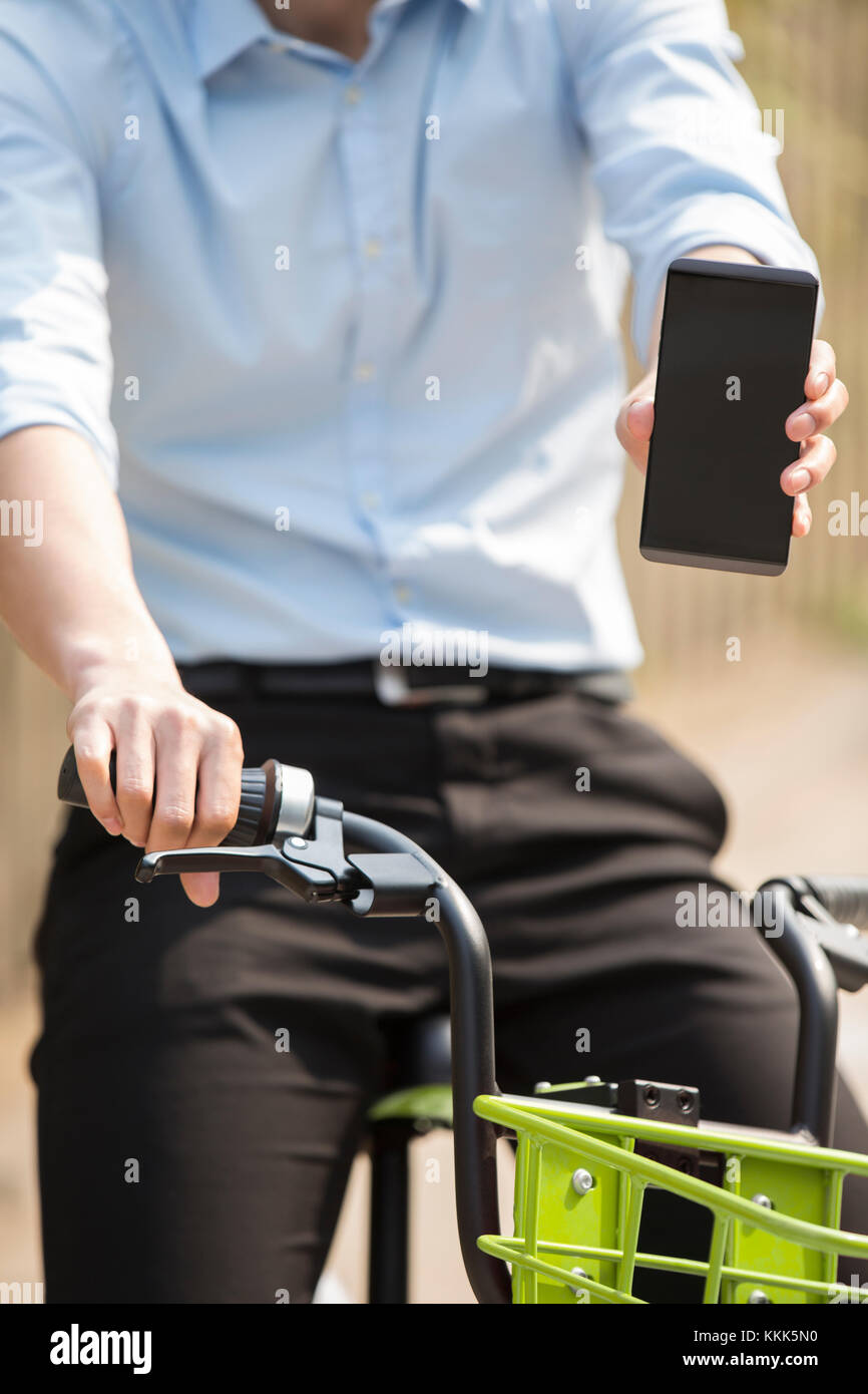 Young Chinese man riding a share bike Stock Photo - Alamy