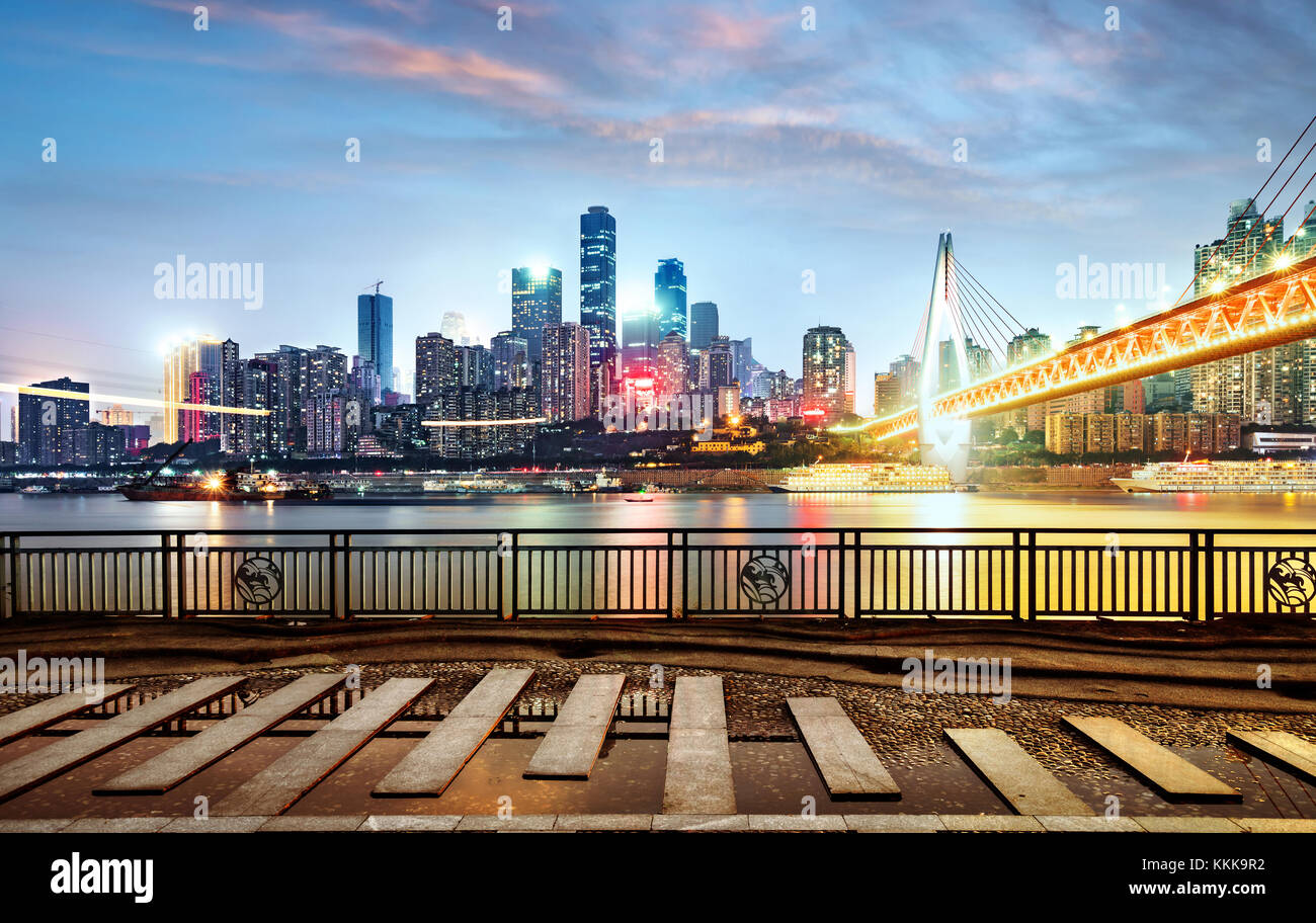 cityscape and skyline of downtown near water of chongqing at night ...