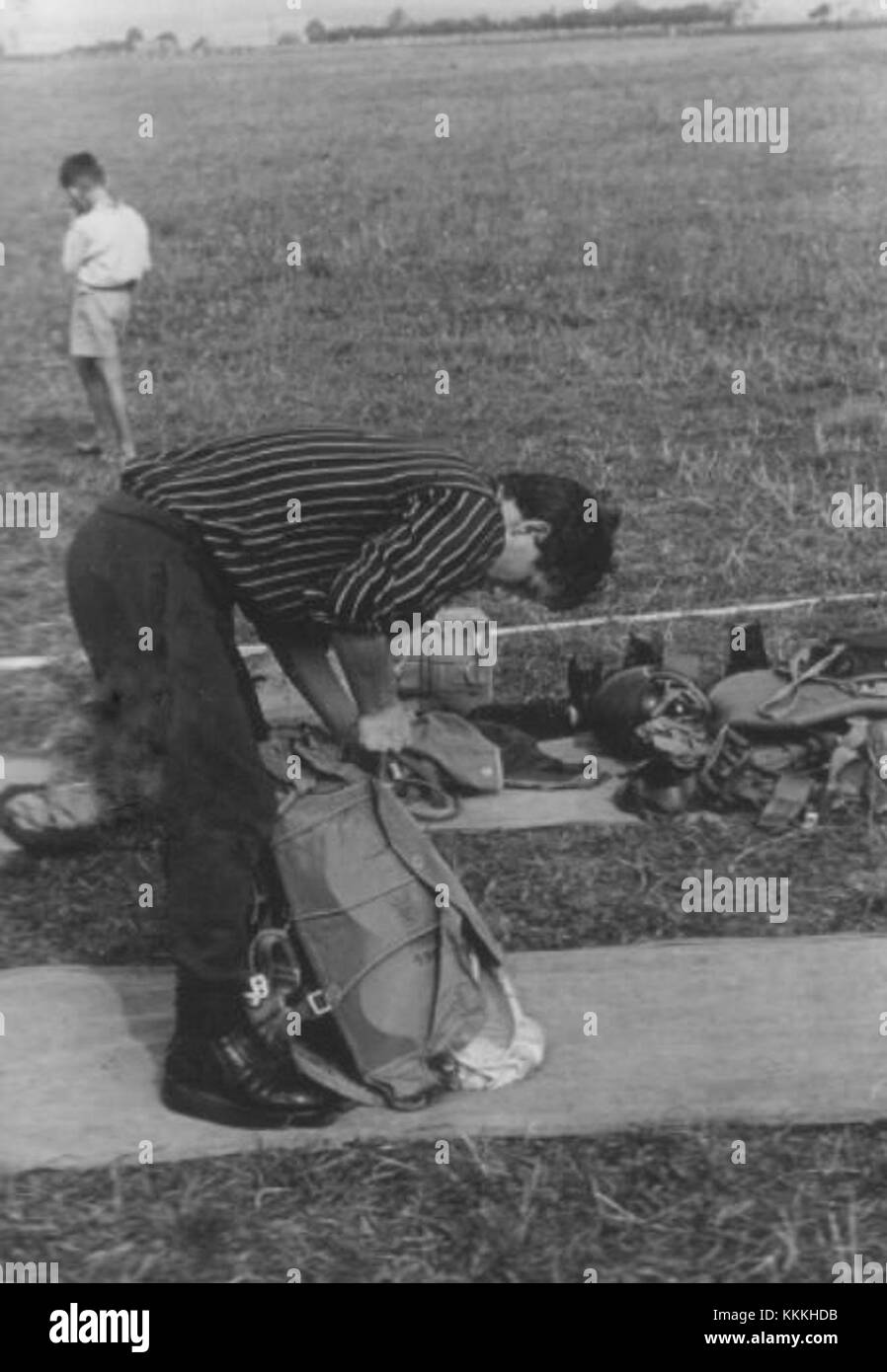The image shows the process of parachute packing, an essential task in ...