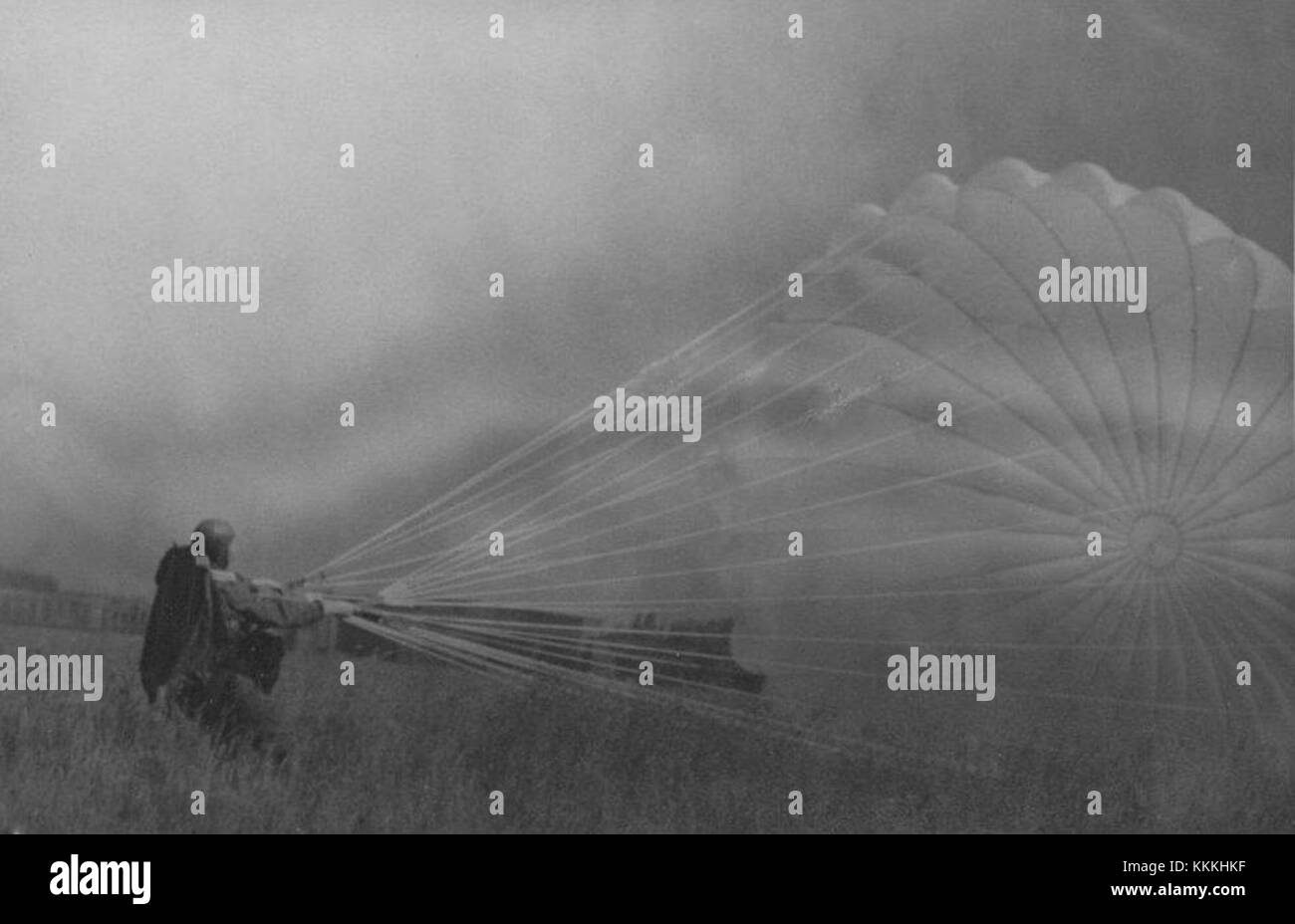 A photograph showing the action of extinguishing a parachute canopy ...