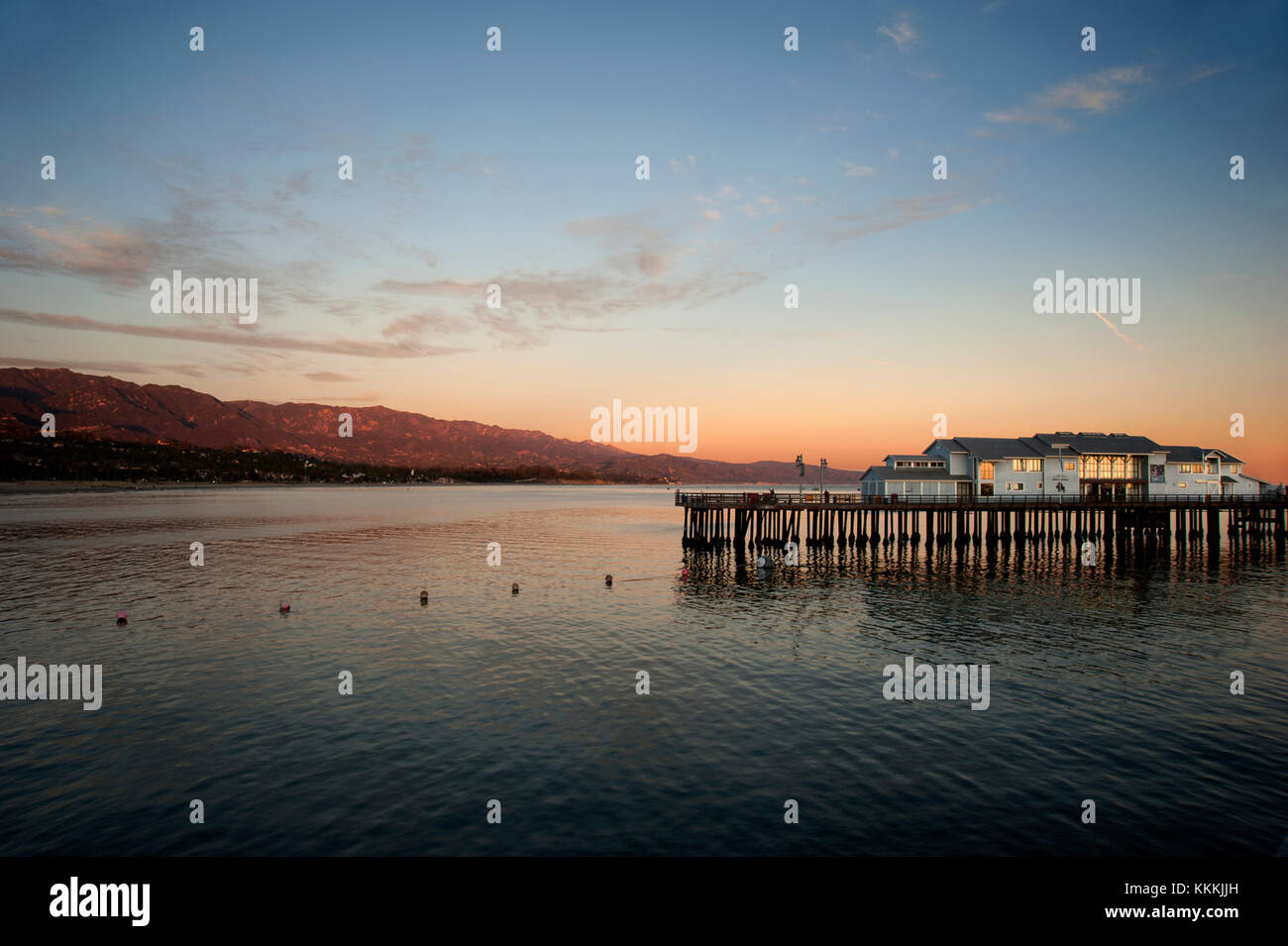 View of southern California coast with Santa Barbara pier at sunset ...