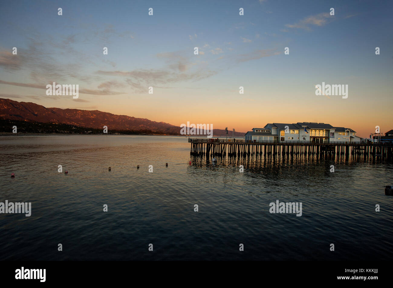 View of southern California coast with Santa Barbara pier at sunset ...