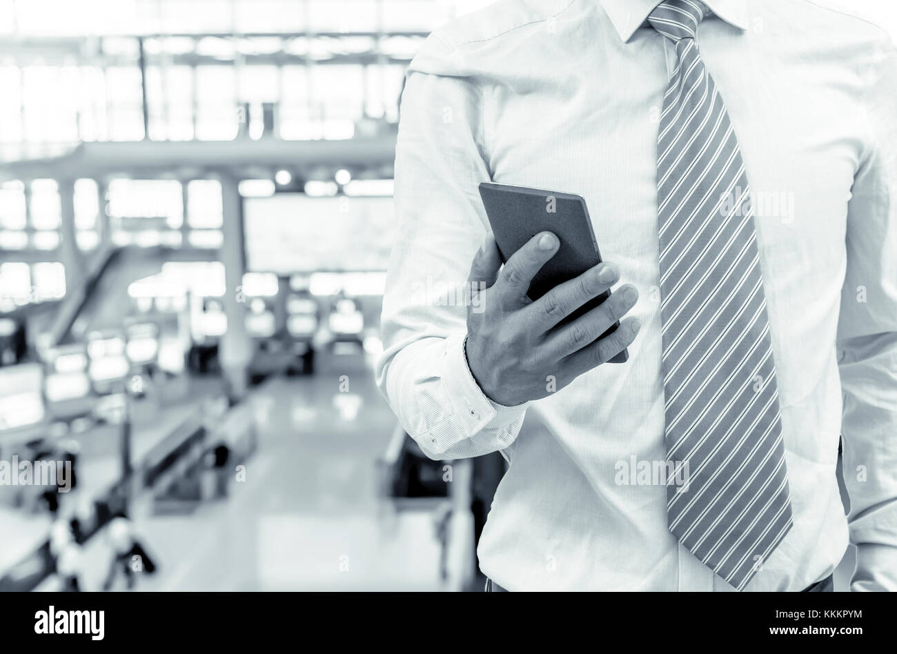 isolated business man hold the smartphone on airport background with ...