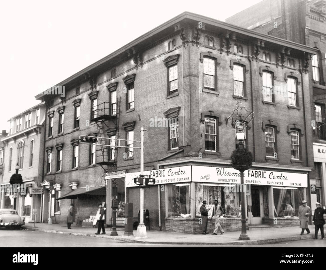 This historical photograph captures the southwest corner of Sixth and ...