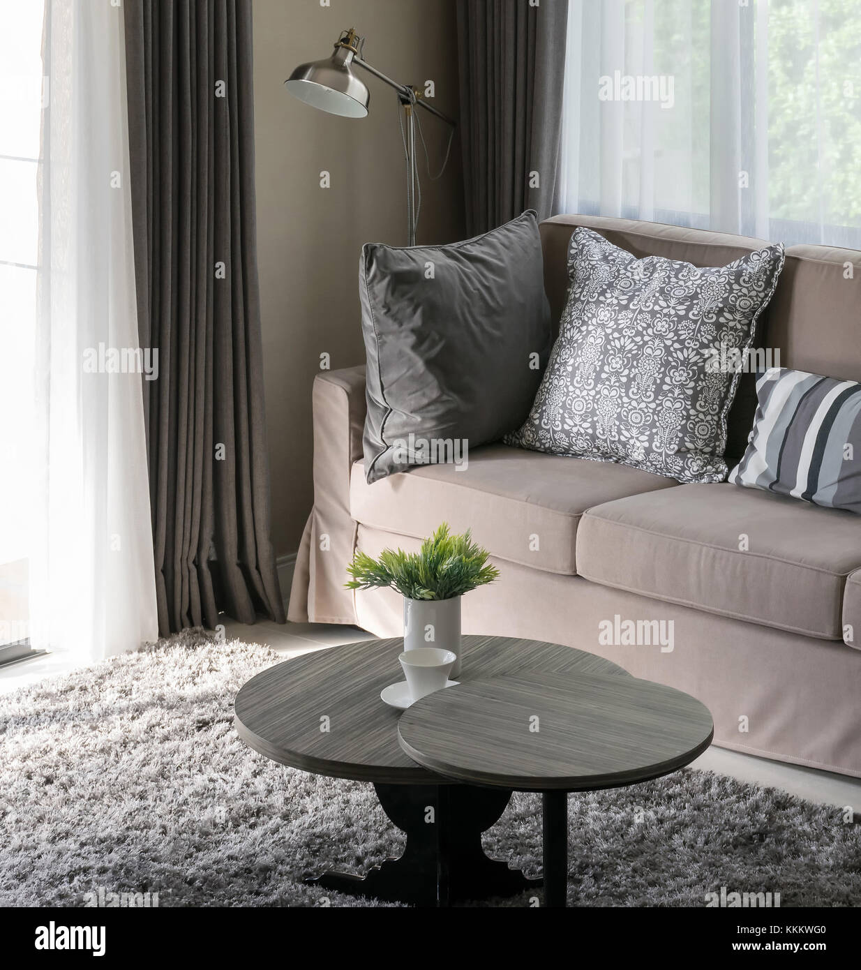 Sturdy brown tweed sofa with grey patterned pillows Stock Photo - Alamy