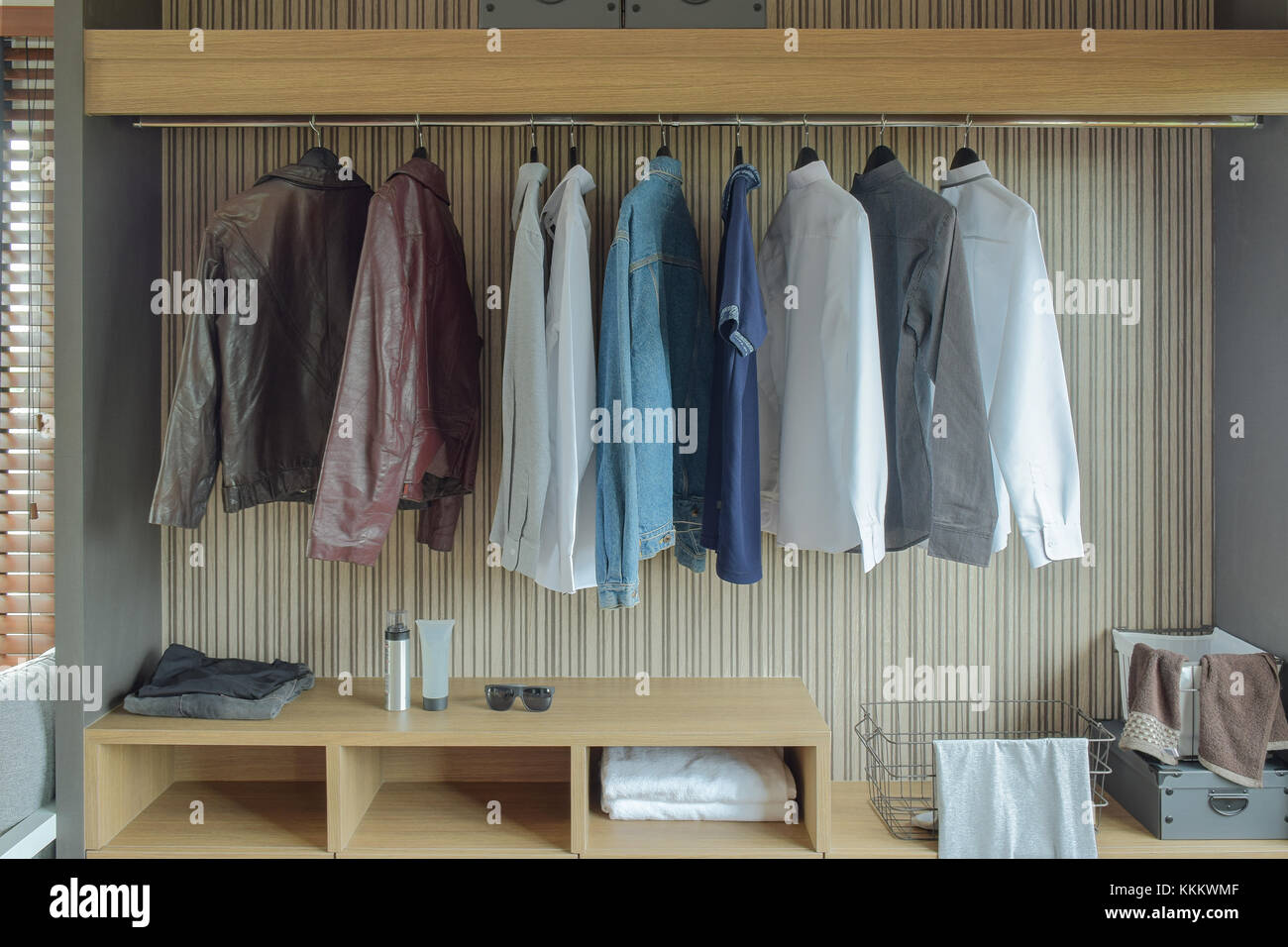 Jackets and shirts in brown color wardrobe Stock Photo - Alamy