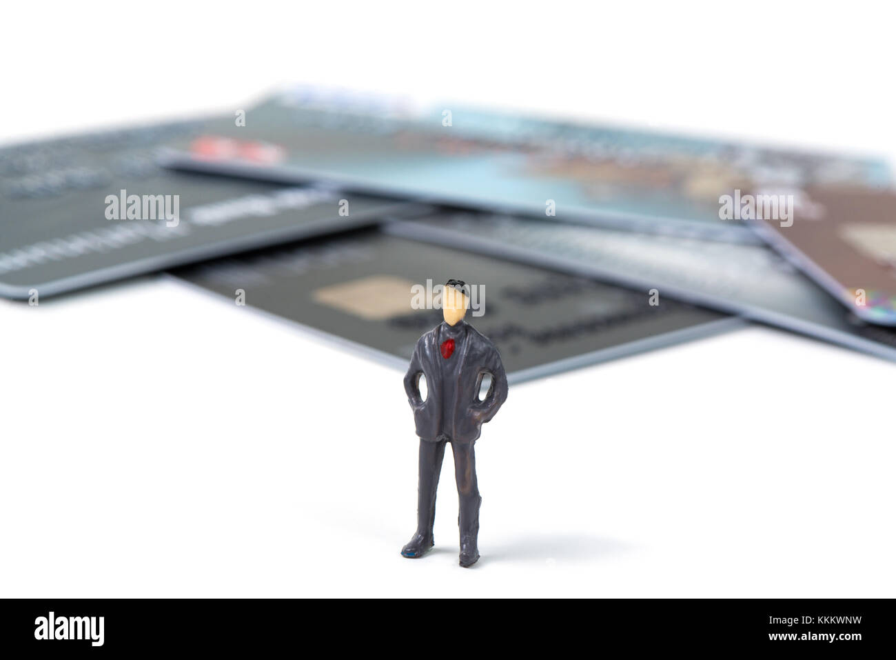 Figure miniature businessman or small people standing with stack of ...