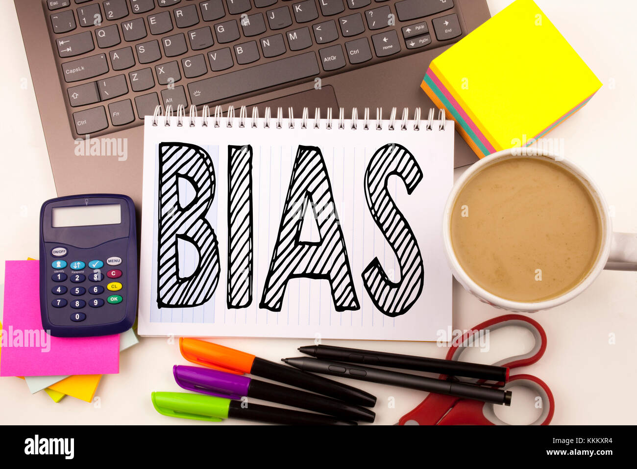 Word writing Bias in the office with laptop, marker, pen, stationery ...