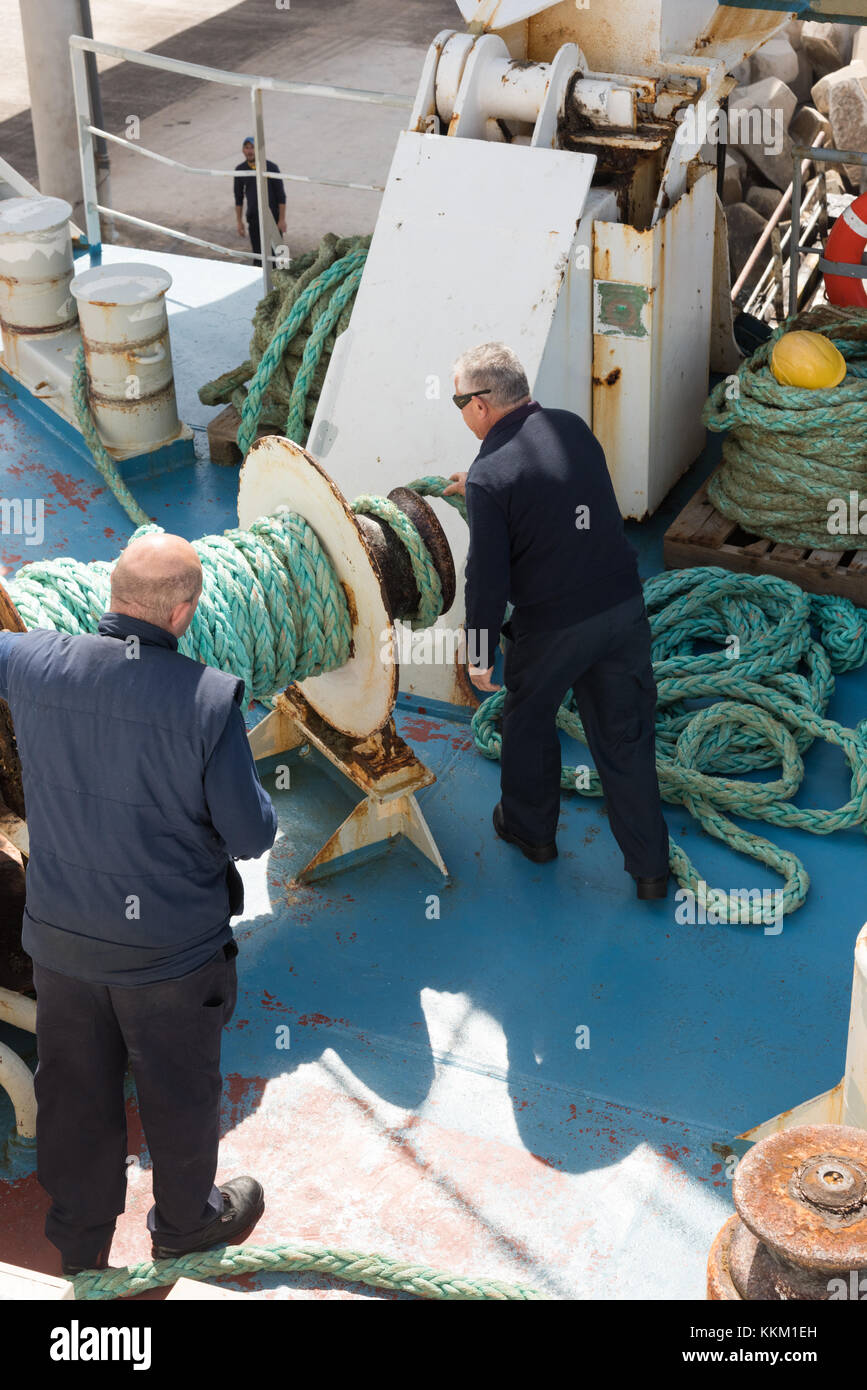 Workers on a Gozo Channel line Ferry boat operating machinery and ...