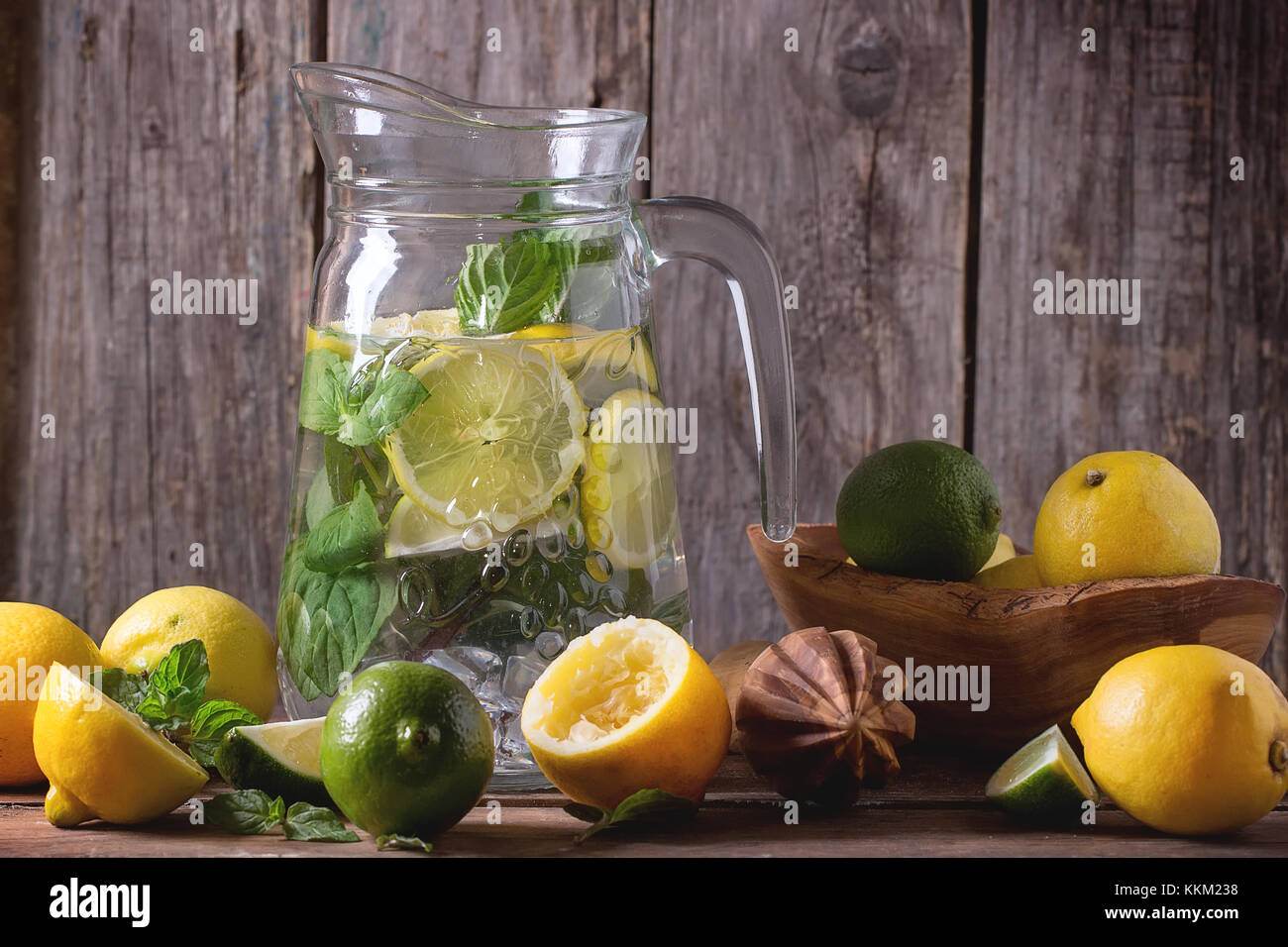 Glass pitcher of homemade lemonade, served with whole and sliced lemons ...