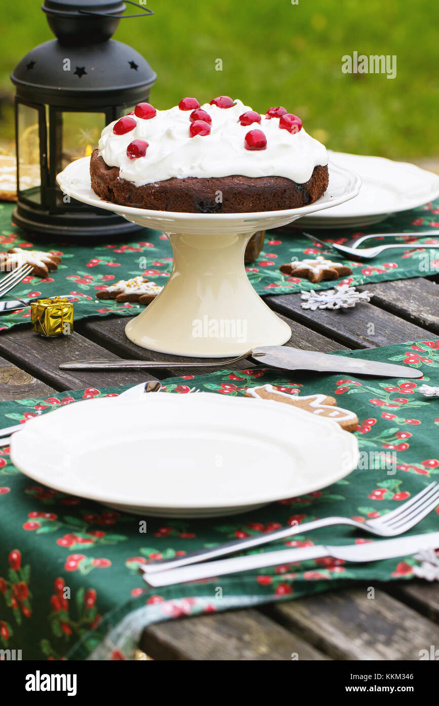Outdoor Christmas table setting with chocolate cherry cake. See series ...