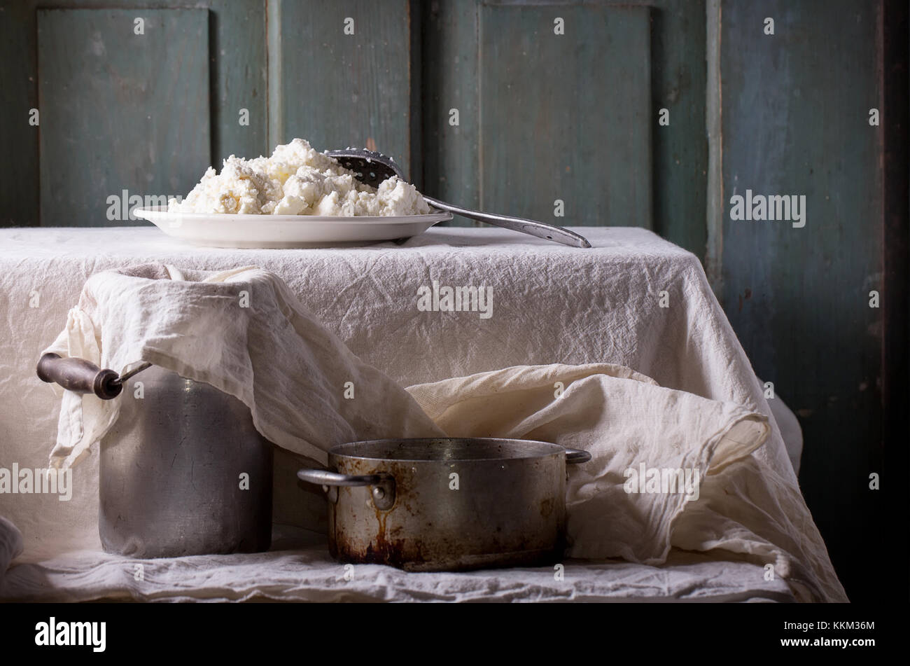 Plate of homemade cottage cheese, served with vintage aluminum pan and ...