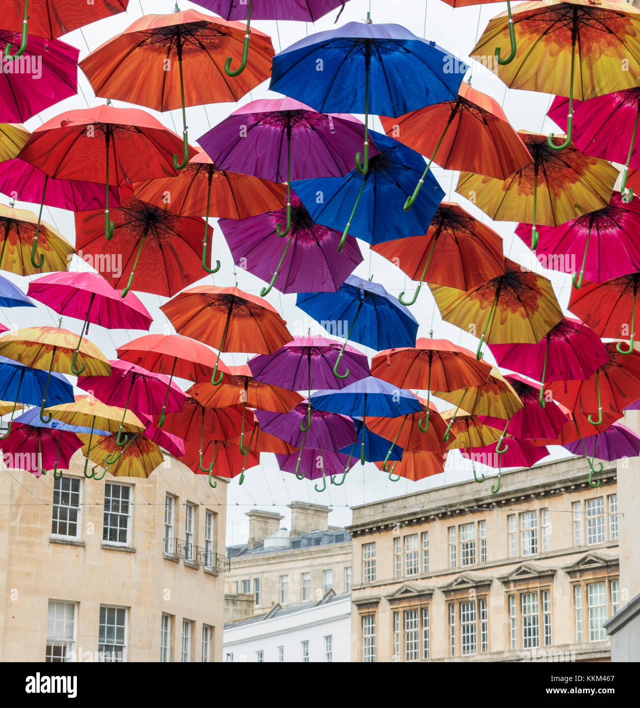 Open umbrellas hanging from wires above the shopping centre of the ...