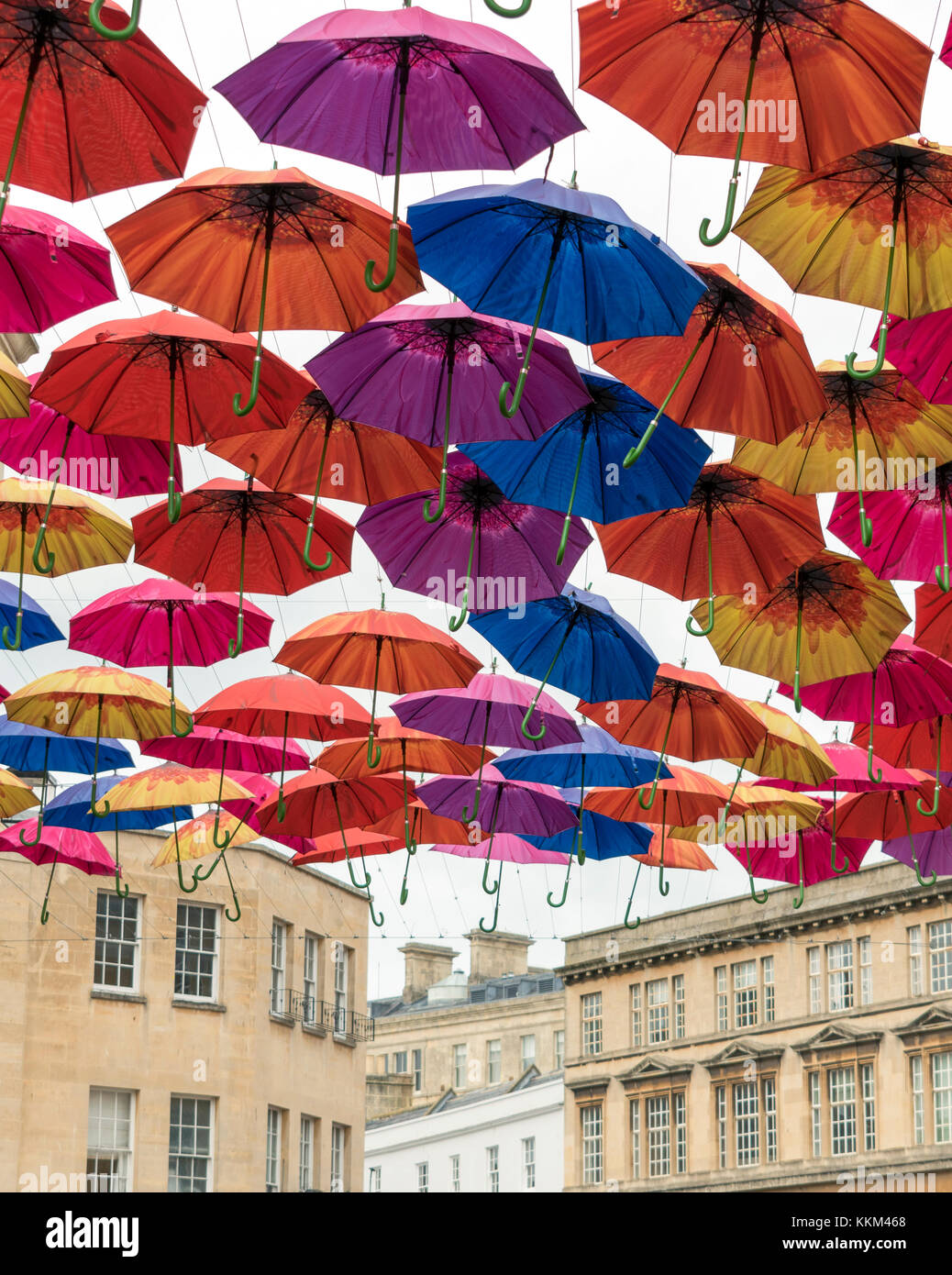 Open umbrellas hanging from wires above the shopping centre of the ...
