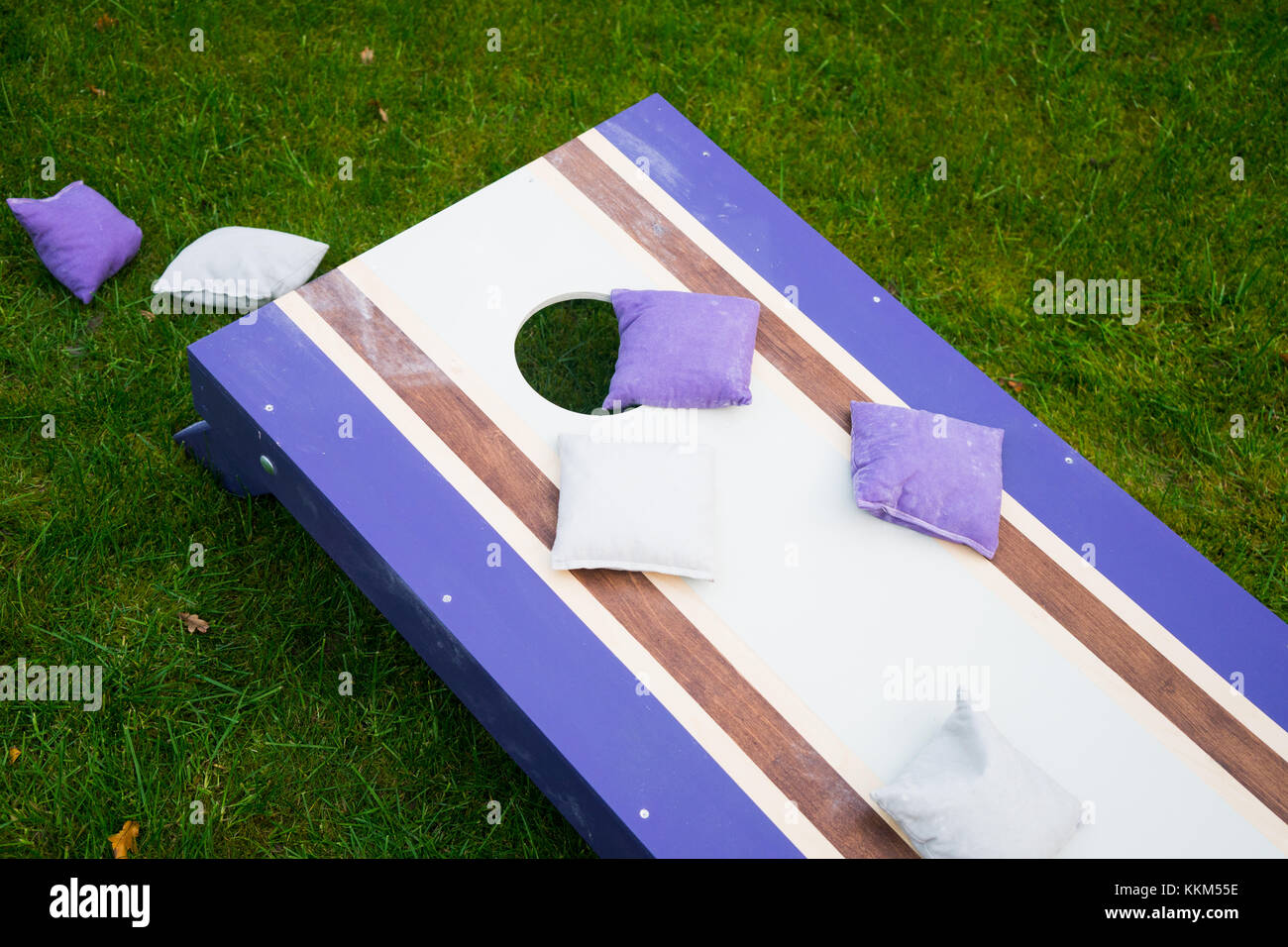 Cornhole beanbag toss wood game board outside on grass Stock Photo - Alamy