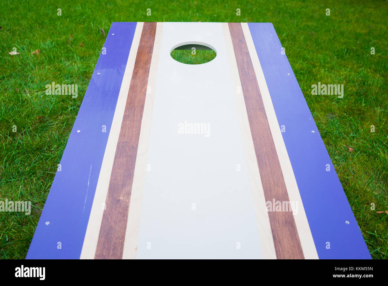 Cornhole beanbag toss wood game board outside on grass Stock Photo - Alamy