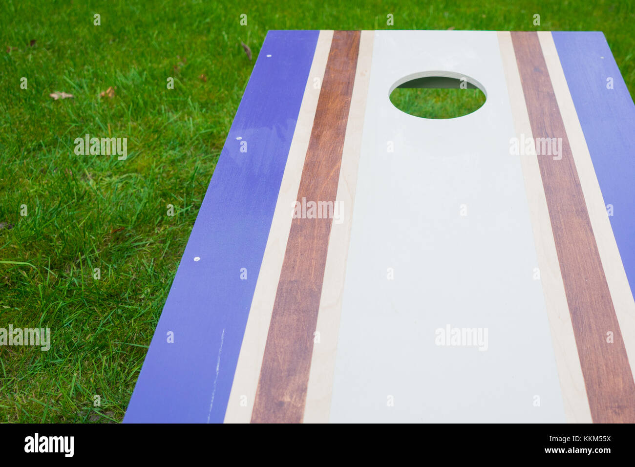 Cornhole beanbag toss wood game board outside on grass Stock Photo - Alamy