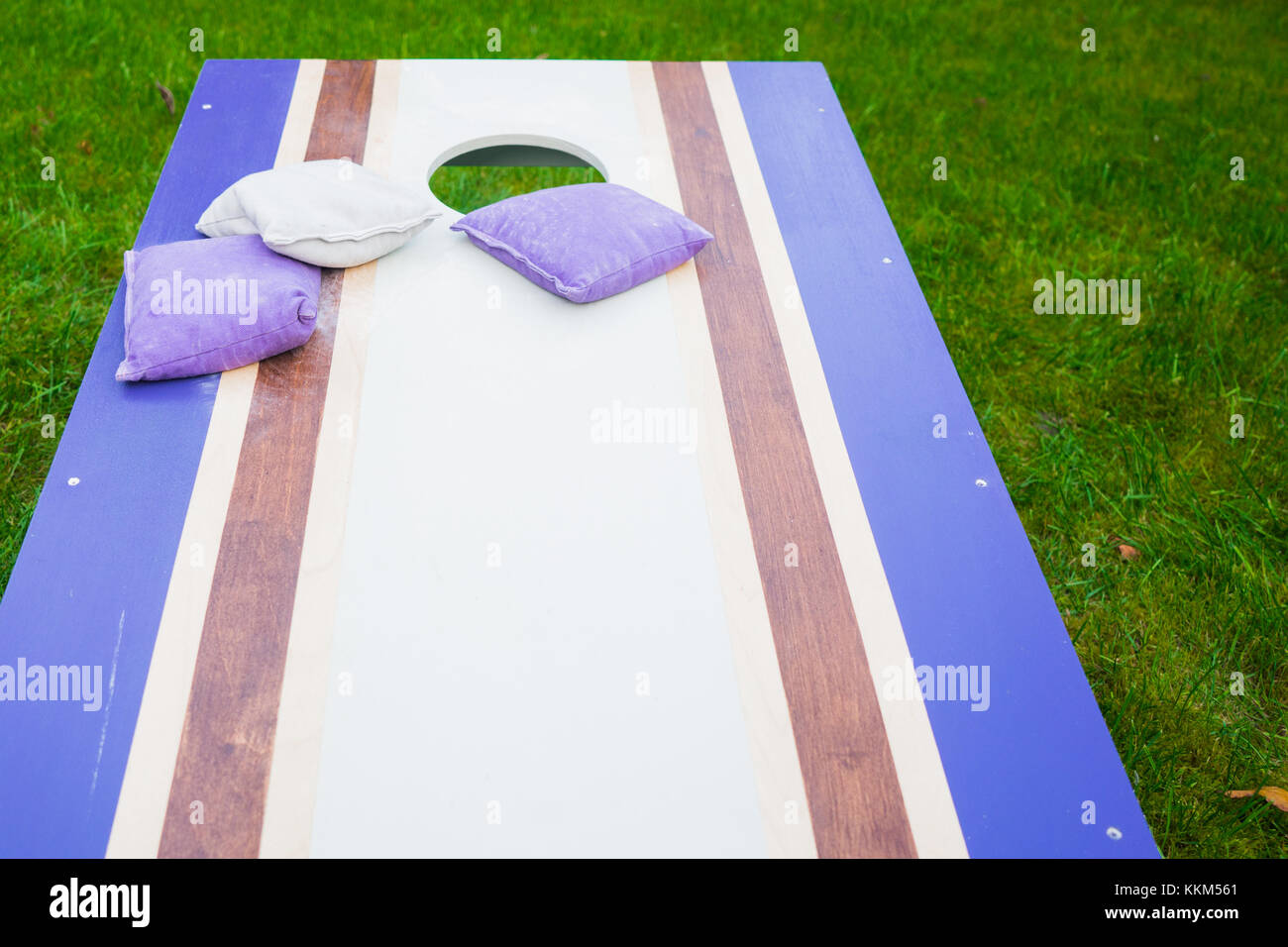 Cornhole beanbag toss wood game board outside on grass Stock Photo - Alamy