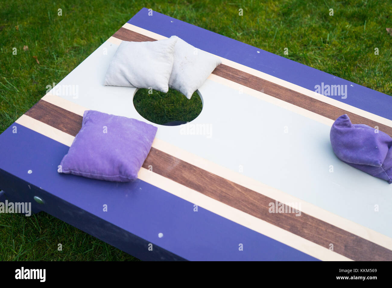 Cornhole beanbag toss wood game board outside on grass Stock Photo - Alamy