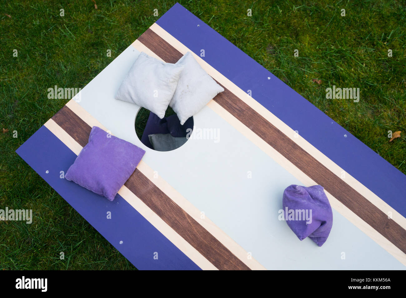 Cornhole beanbag toss wood game board outside on grass Stock Photo - Alamy
