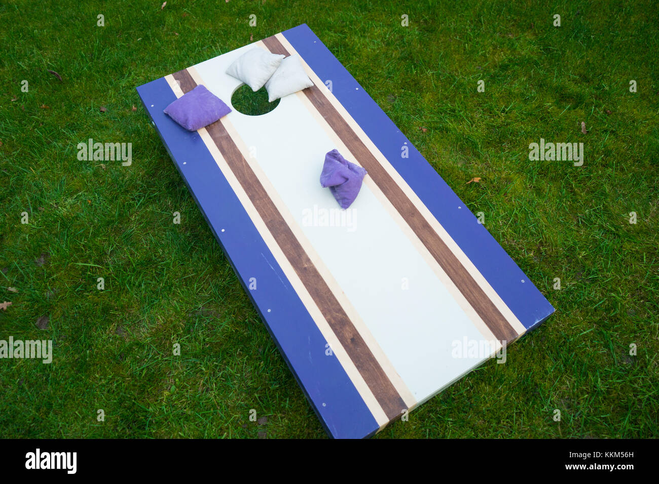 Cornhole beanbag toss wood game board outside on grass Stock Photo - Alamy
