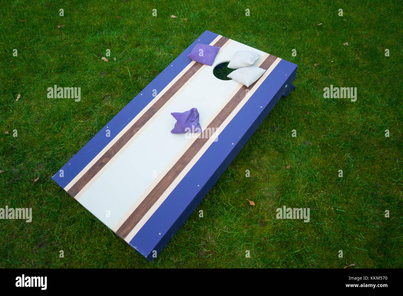 Cornhole beanbag toss wood game board outside on grass Stock Photo - Alamy