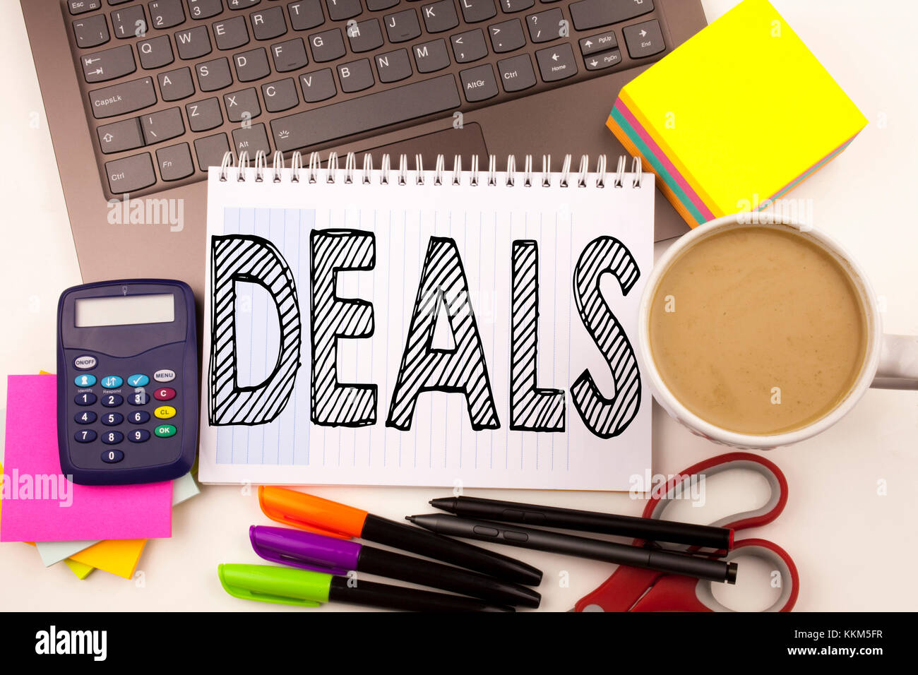 Word writing Deals in the office with laptop, marker, pen, stationery ...