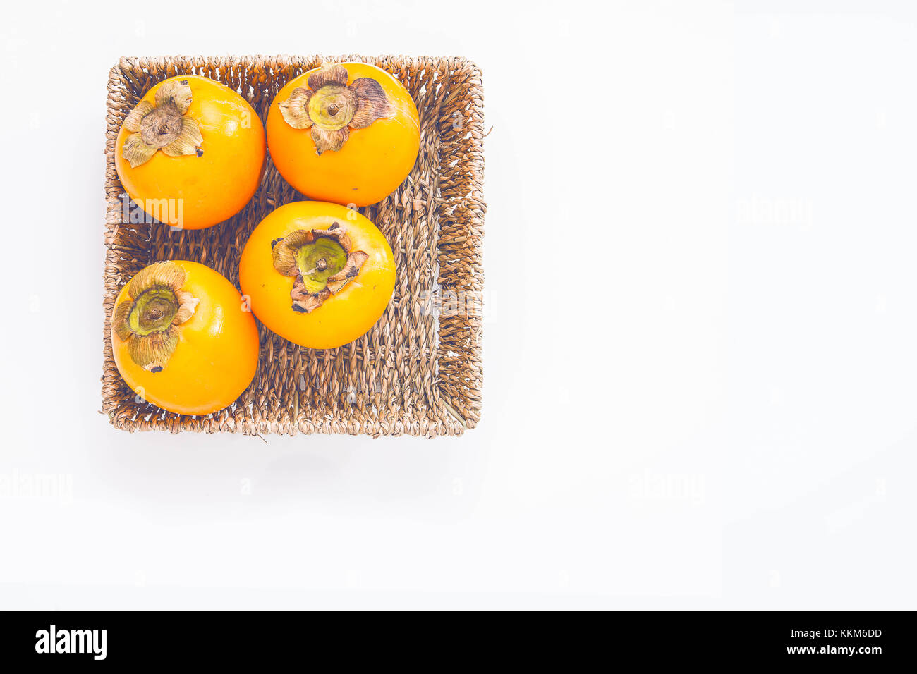 Fresh natural kaki fruits in the basket on white background Stock Photo ...