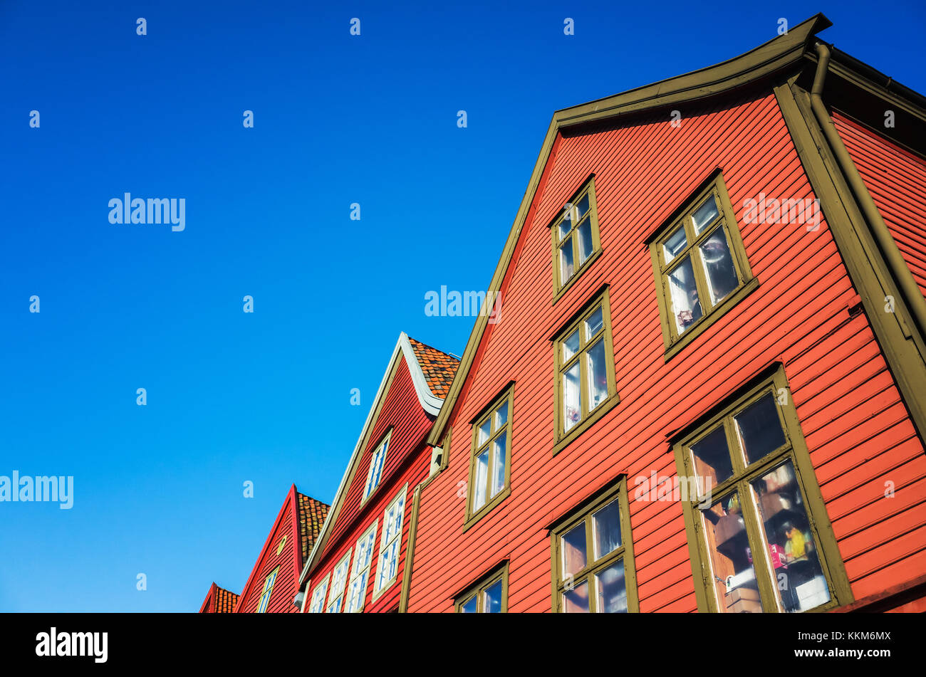 Traditional Norwegian red wooden houses under deep blue sky, Bergen ...