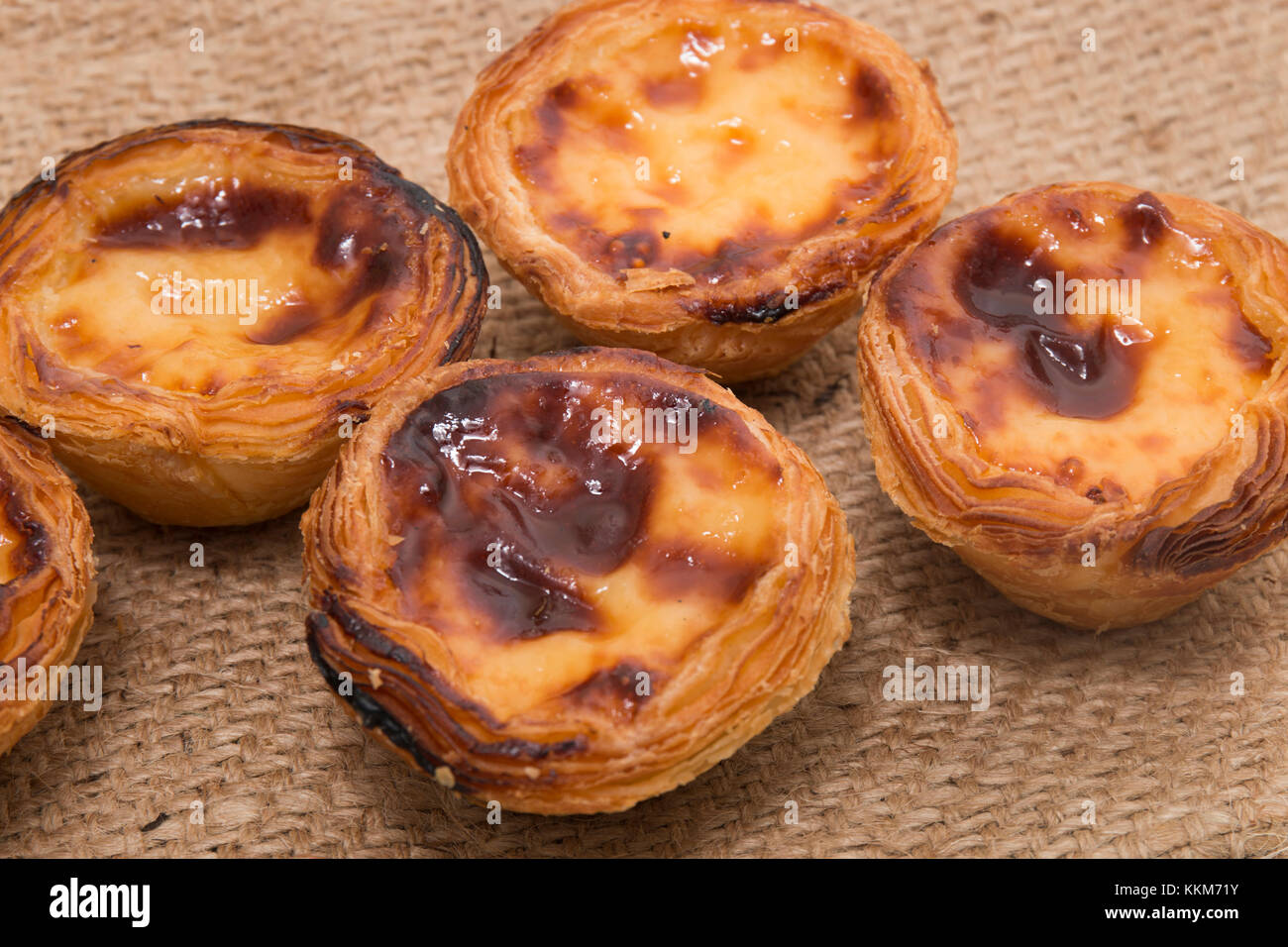Famous Portuguese egg pastry tart called 'Pastel de Belem' on hessian ...
