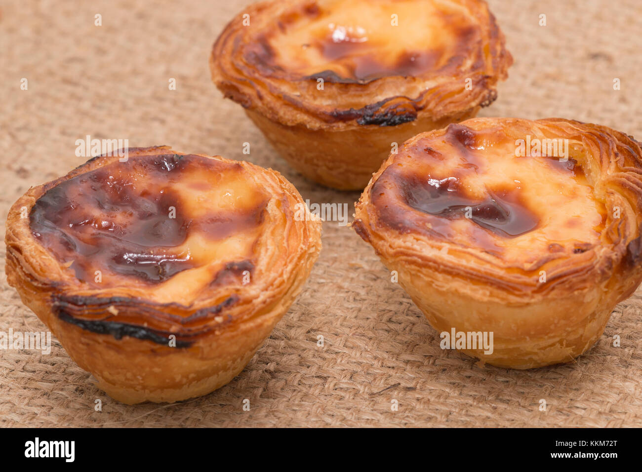 Famous Portuguese egg pastry tart called 'Pastel de Belem' on hessian ...